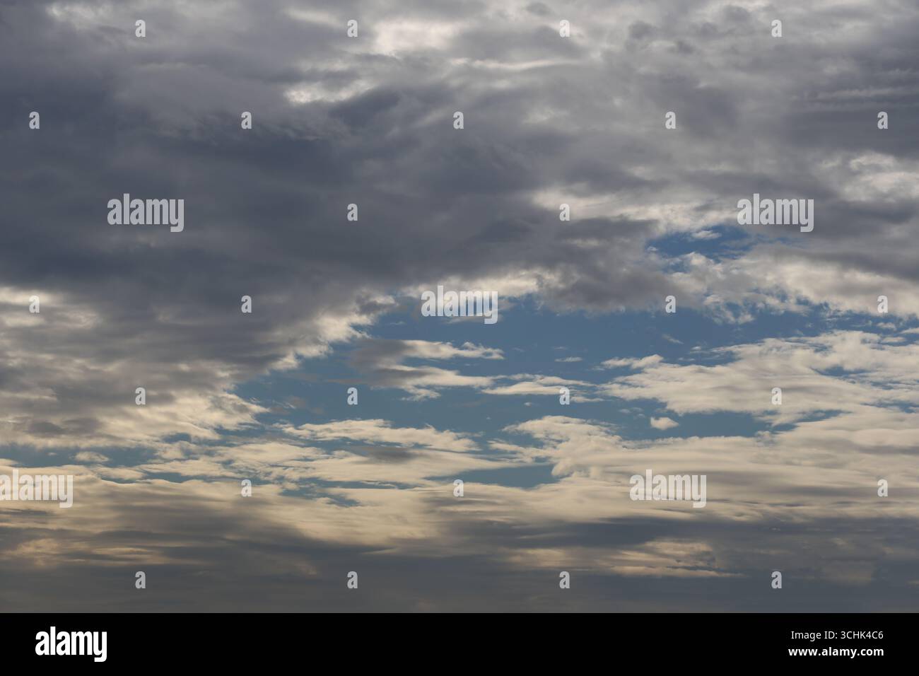 A captivating view of a cloudy sky showcases a blend of light gray and ...