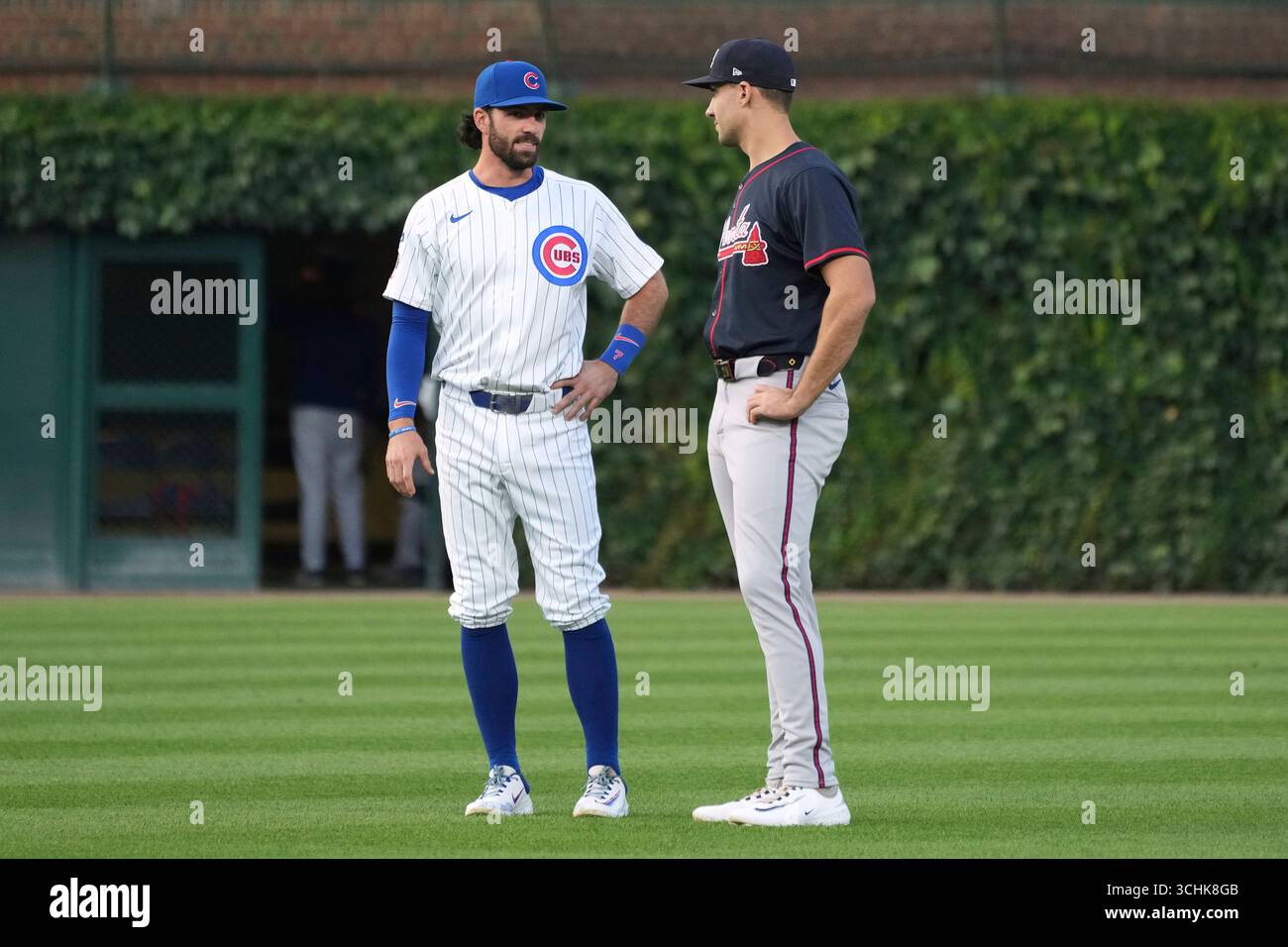 Chicago Cubs' Dansby Swanson, left, talks with Atlanta Braves' Matt ...