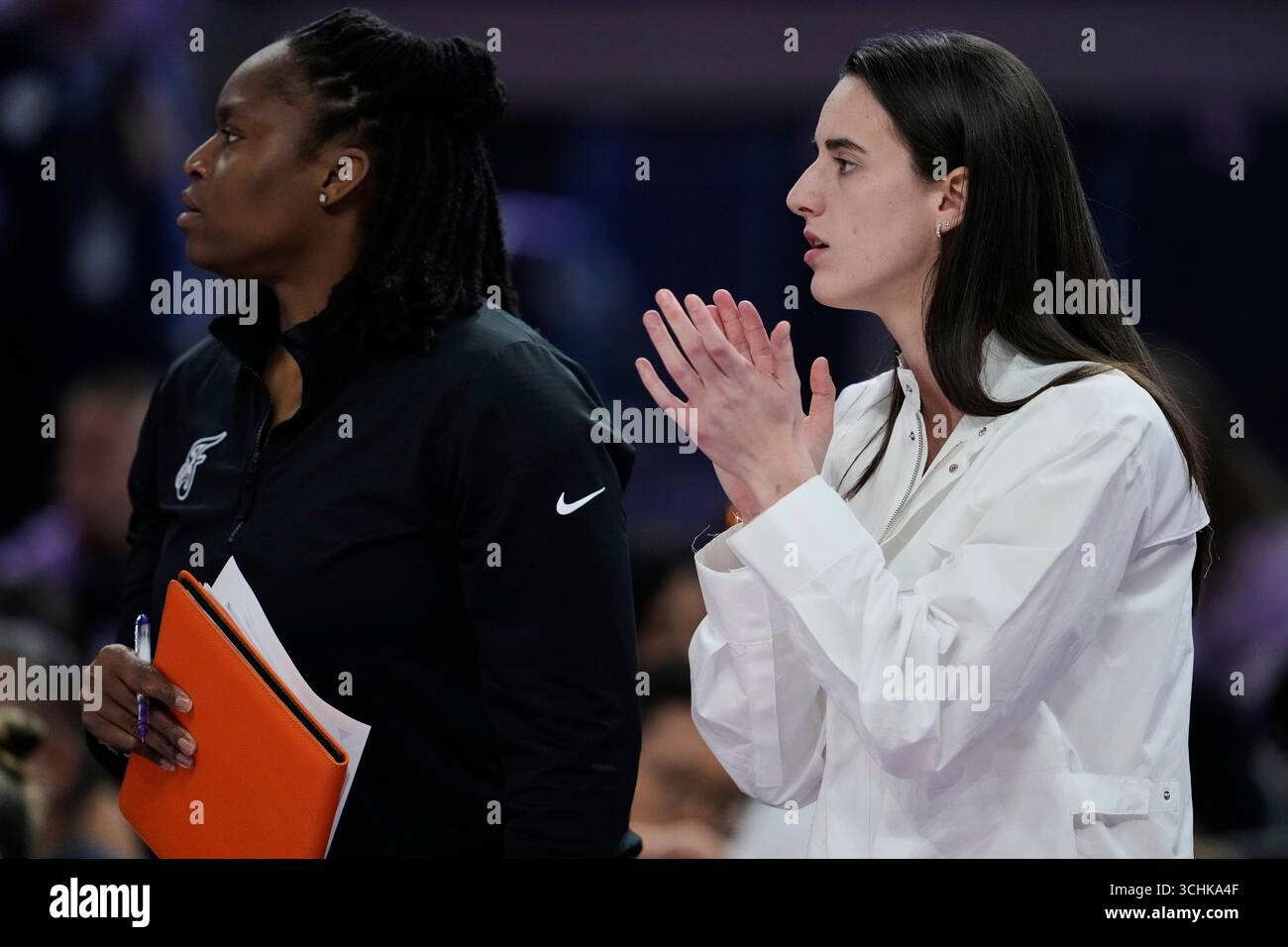 Indiana Fever's Caitlin Clark, right, watches from the bench during the ...