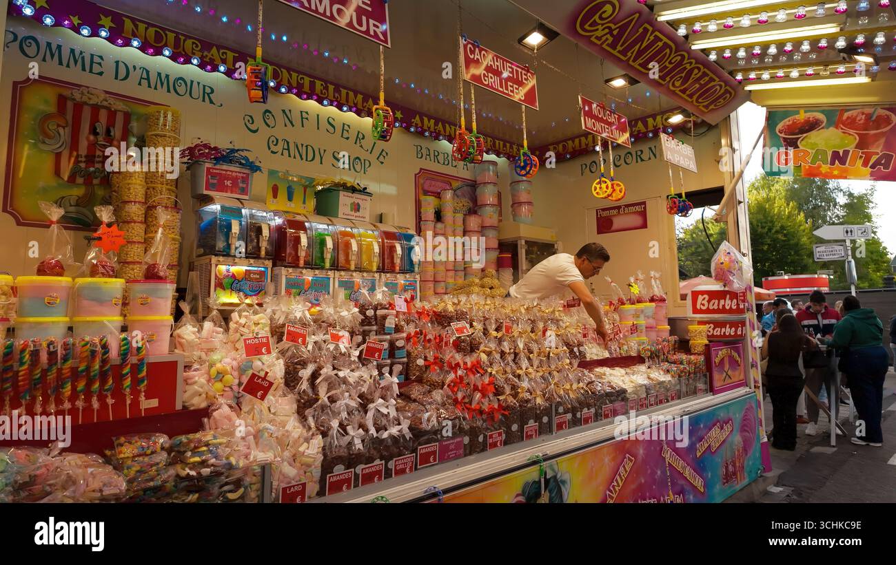 LUXEMBURG, EUROPE - SEPTEMBER 1, 2025 - Candy shop vendor arranging ...