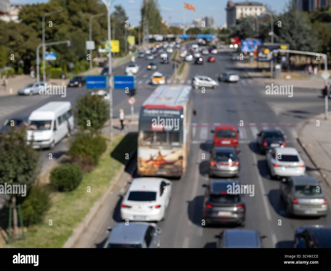 traffic jam in a bustling city intersection, cars and bus moving slowly ...