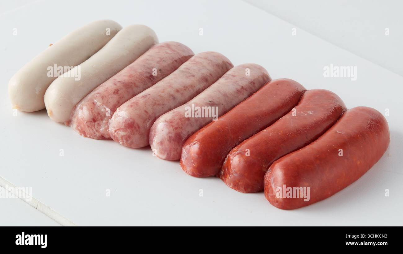 Fresh sausages lined up in long rows isolated nature background with ...
