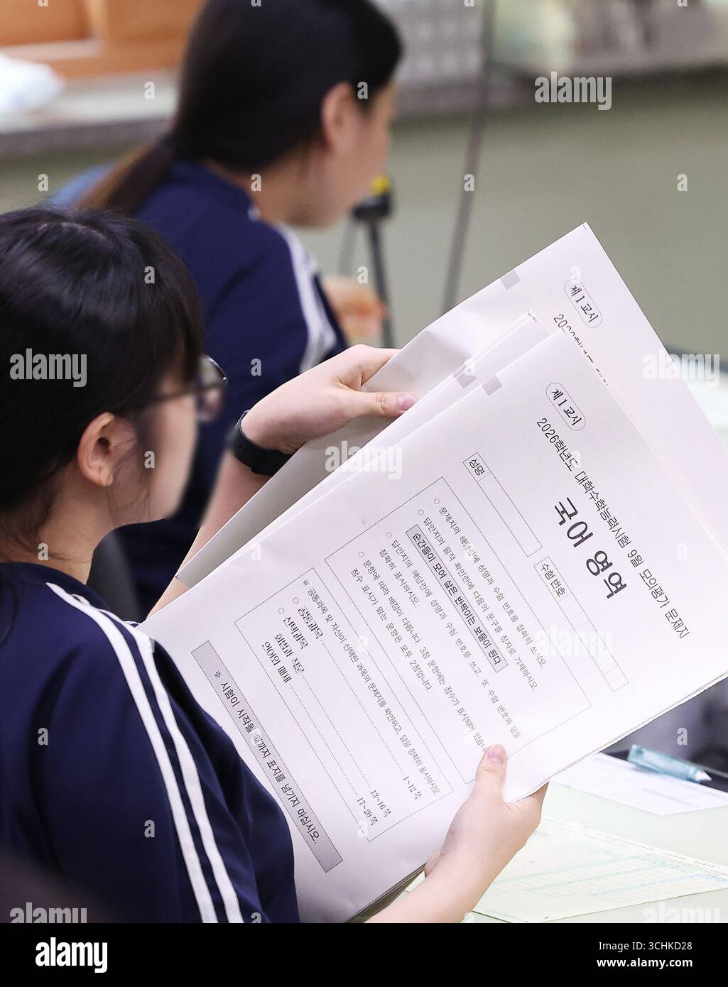 Scholastic ability test at high school A senior distributes test papers ...