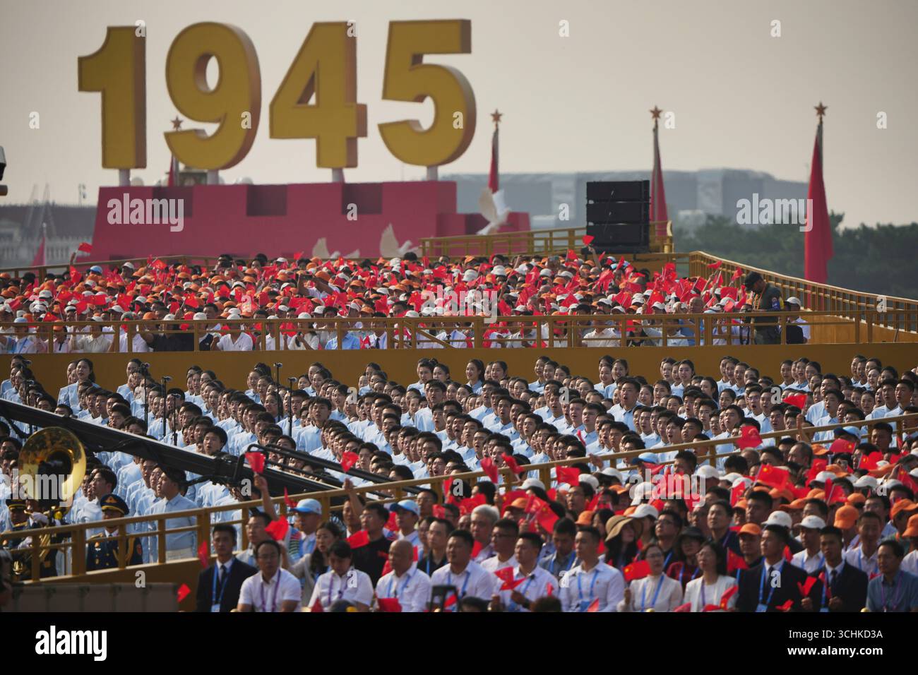 Spectators react ahead of a military parade to commemorate the 80th ...