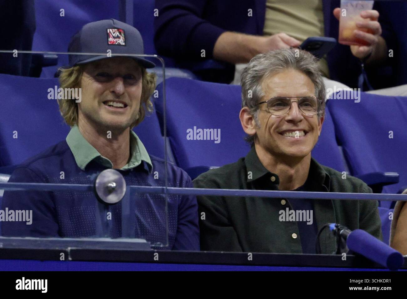 Ben Stiller and Owen Wilson watch a match between Novak Djokovic, of ...