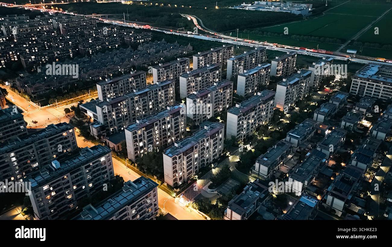 Aerial view of modern residential apartment buildings at night with ...