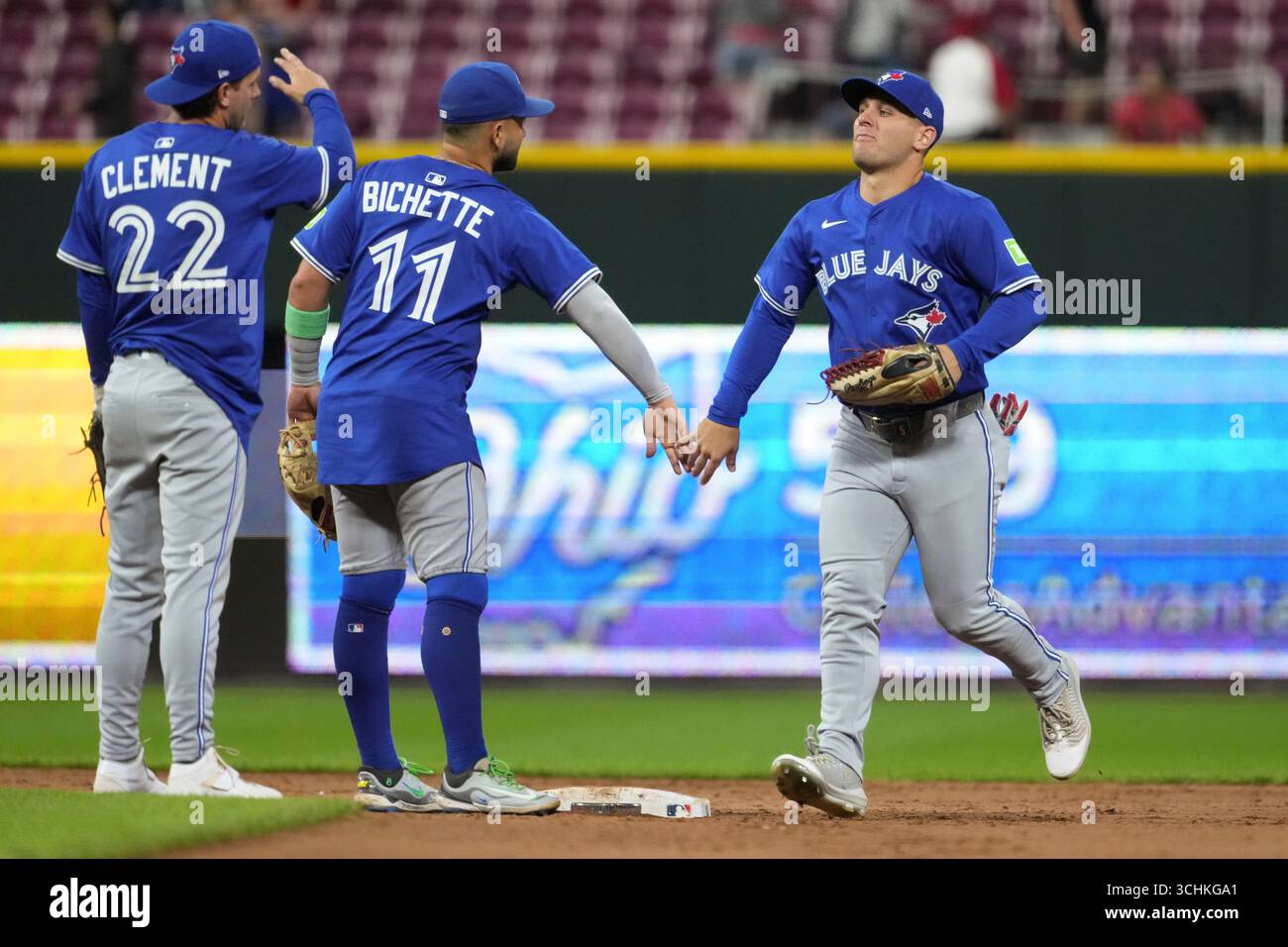 Toronto Blue Jays' Daulton Varsho, right, slaps hands with ' Bo ...