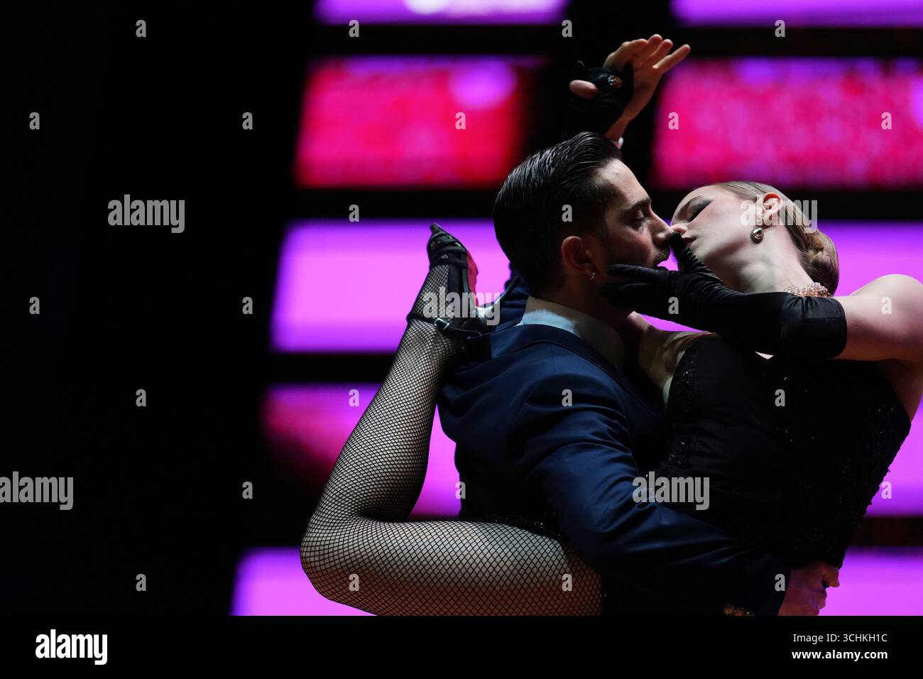 A couple competes in the stage category finals of the World Tango ...