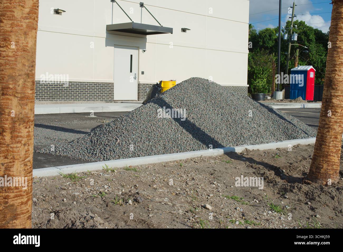 Pile of loose gravel near a building under construction, placed on a ...