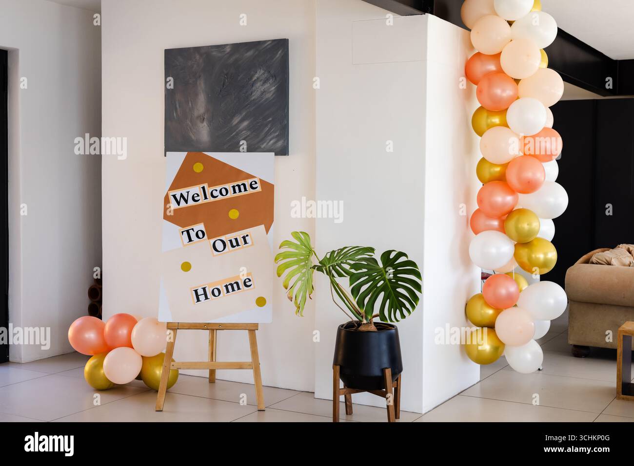 Housewarming, Welcome sign with balloons decorating modern living room ...