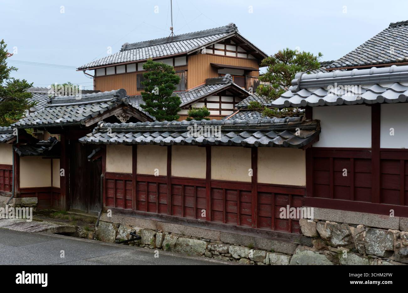 Traditional style entrance gate with stone wall of a single-family, two ...