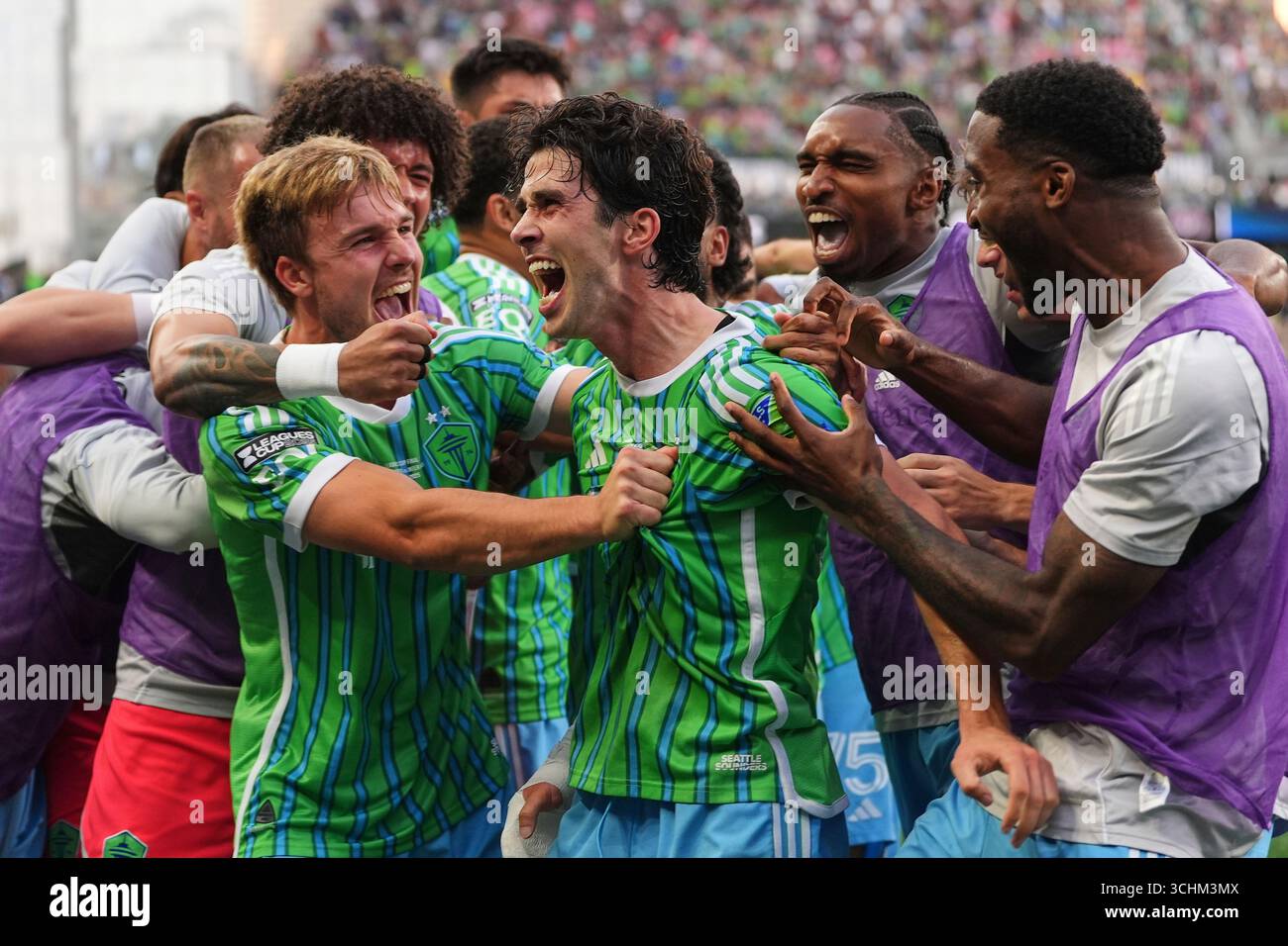 Seattle Sounders midfielder Paul Rothrock, center, reacts with ...