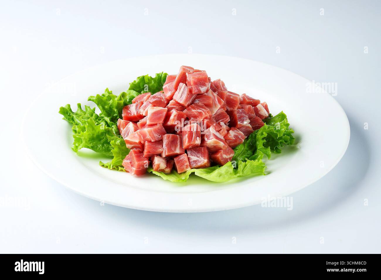 Fresh Diced Lamb Cubes on White Plate Stock Photo - Alamy