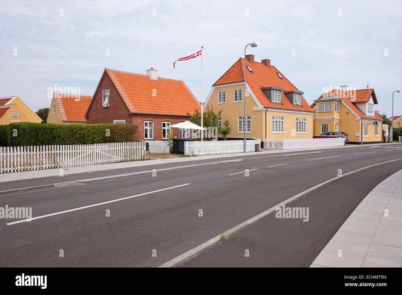 Cluster of traditional Danish houses with red roofs and bright yellow ...