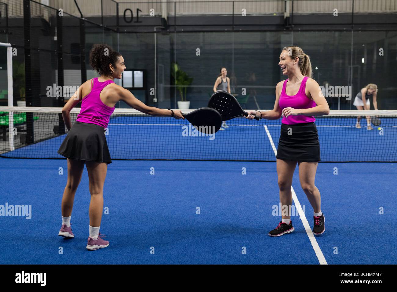 Diverse female friends tapping hi-res stock photography and images - Alamy