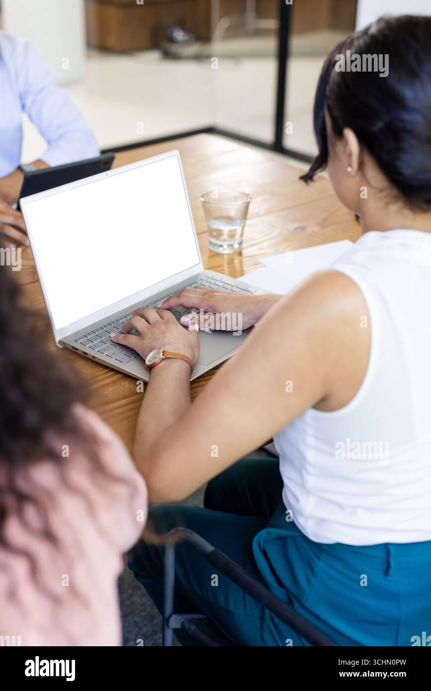 Collaborating professional group typing hi-res stock photography and ...