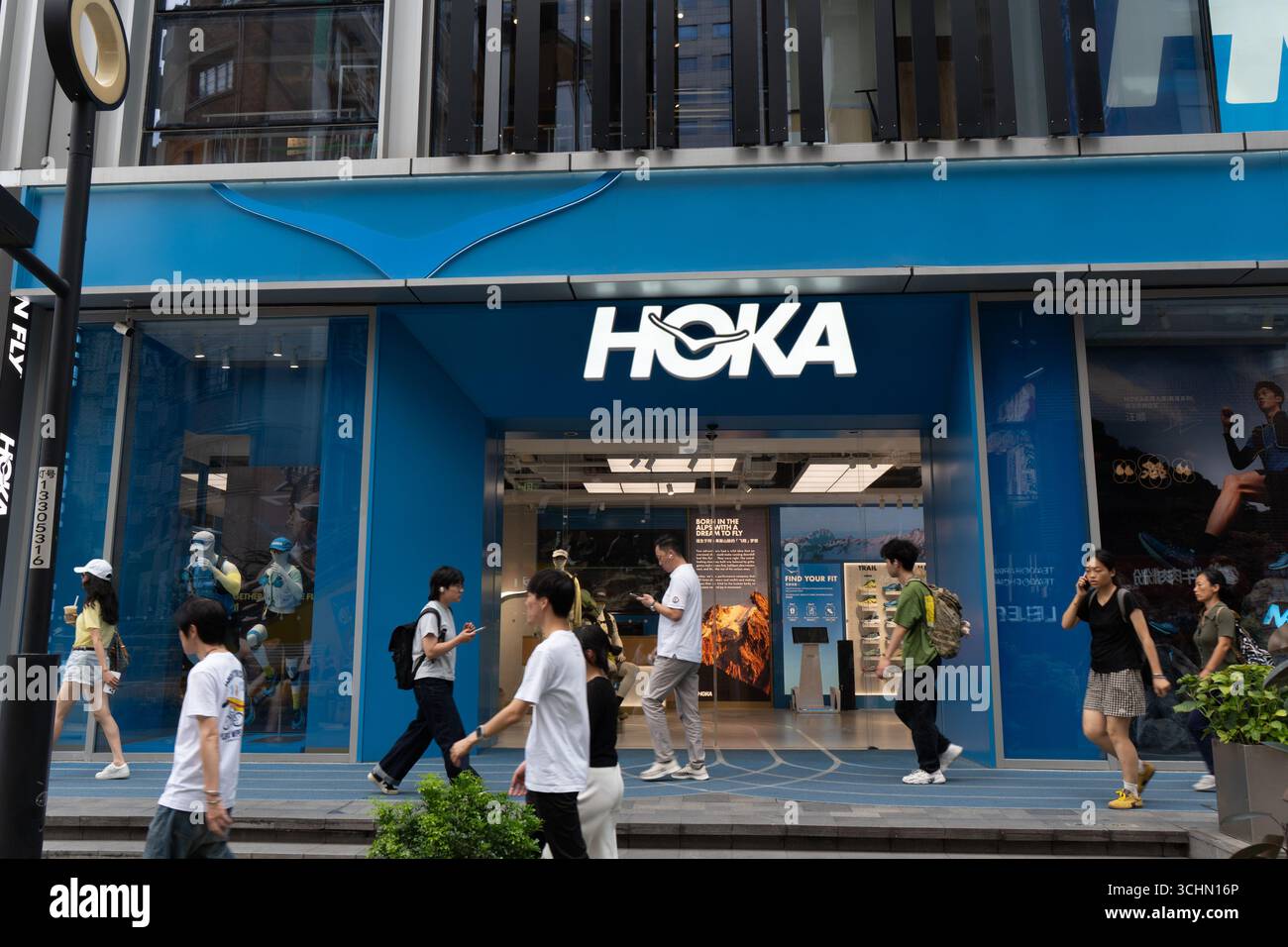 SHANGHAI, CHINA - SEPTEMBER 3, 2025 - Pedestrians pass by the HOKA ...