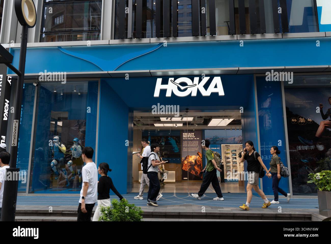 SHANGHAI, CHINA - SEPTEMBER 3, 2025 - Pedestrians pass by the HOKA ...