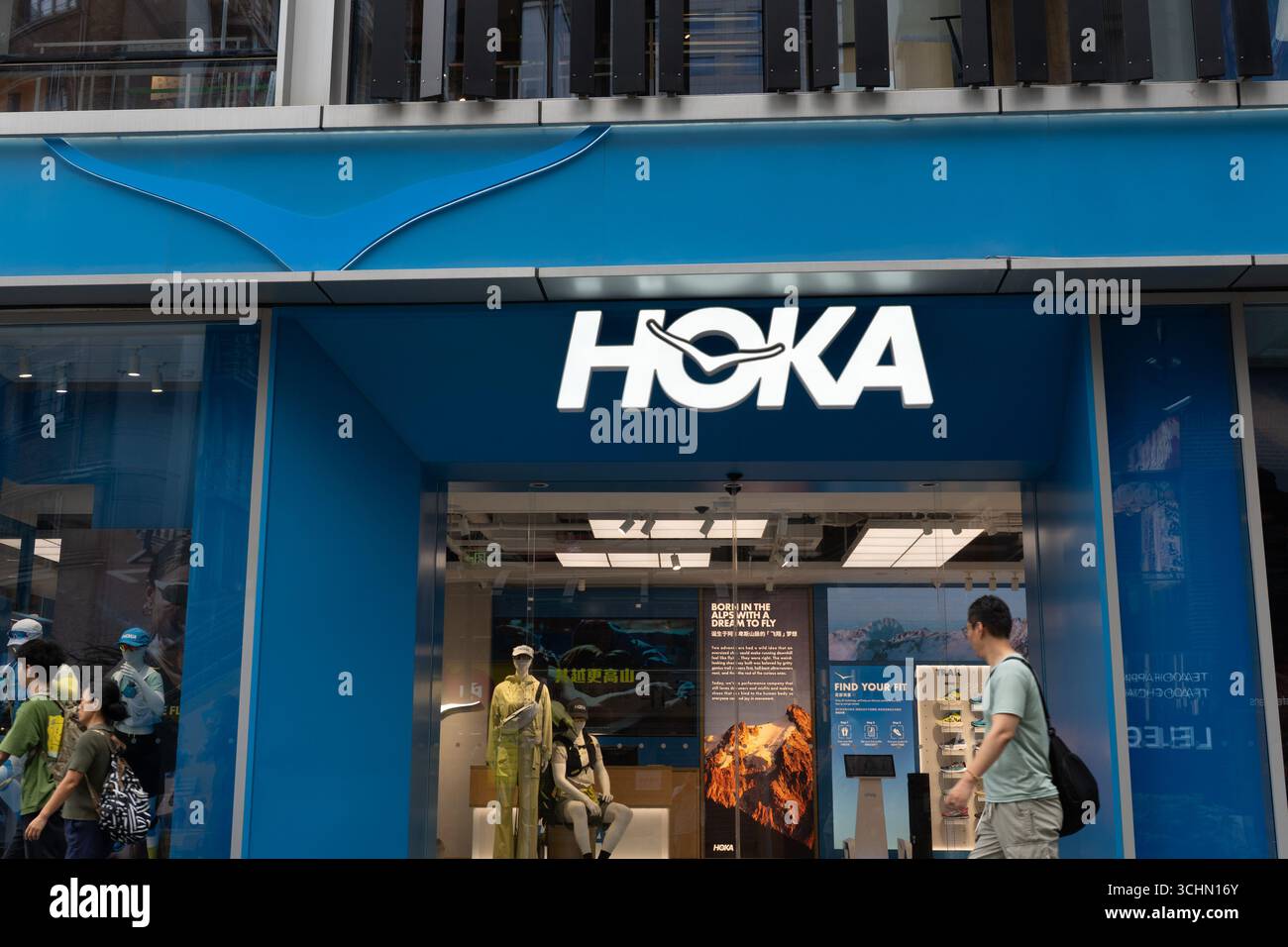 SHANGHAI, CHINA - SEPTEMBER 3, 2025 - Pedestrians pass by the HOKA ...