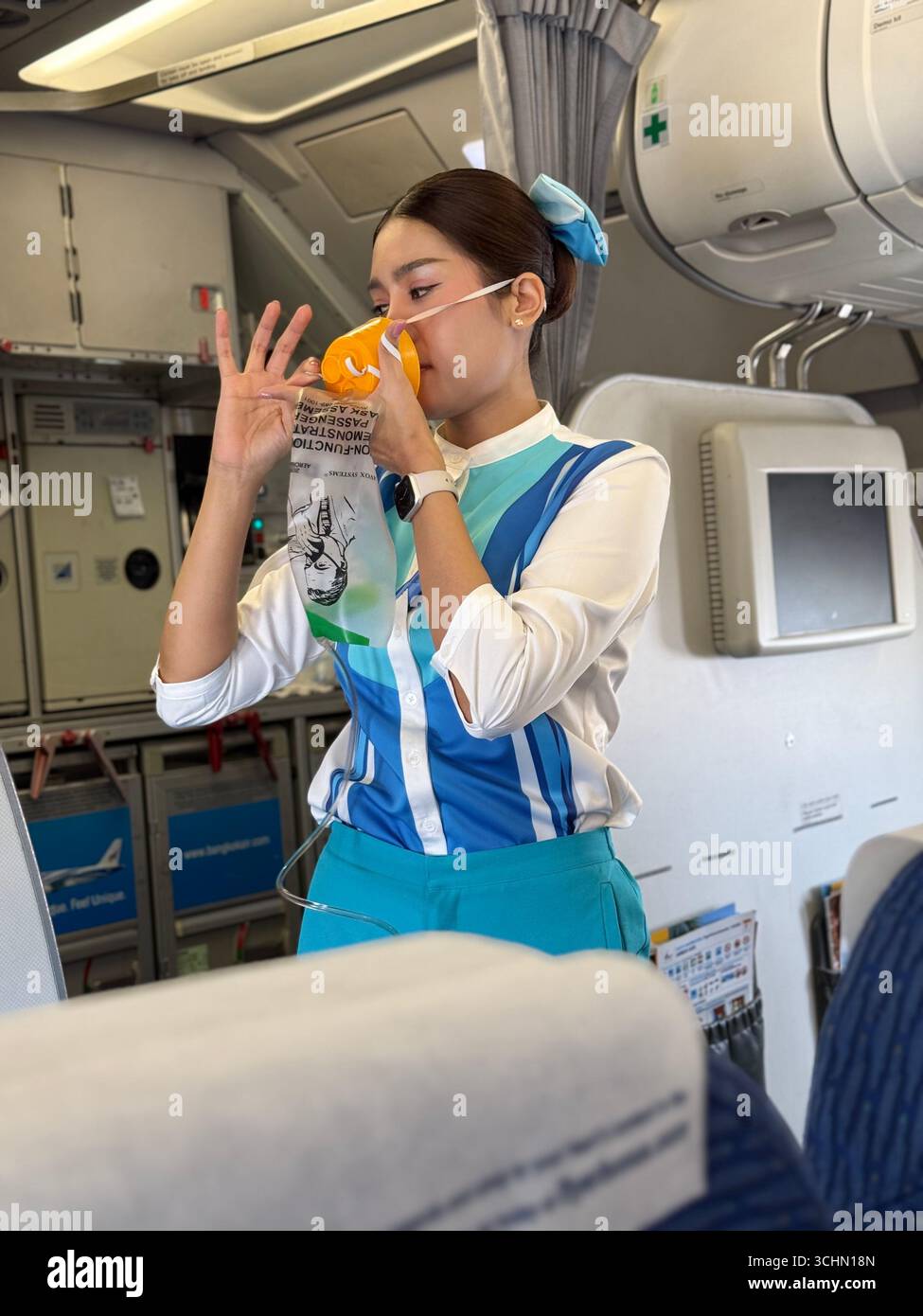 An air stewardess of Bangkok Airways – a regional airline, demonstrates ...