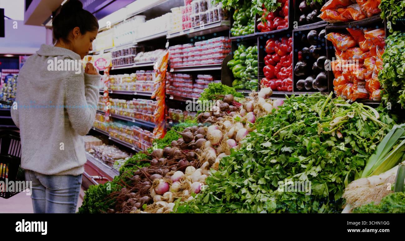 Inspecting produce, woman wearing sweater and carrying black basket in ...