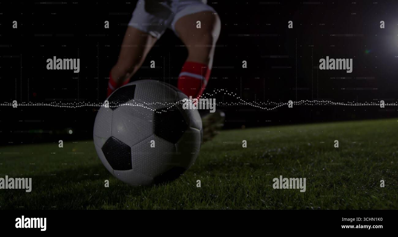 Rolling soccer ball under stadium light on grass field, player in ...