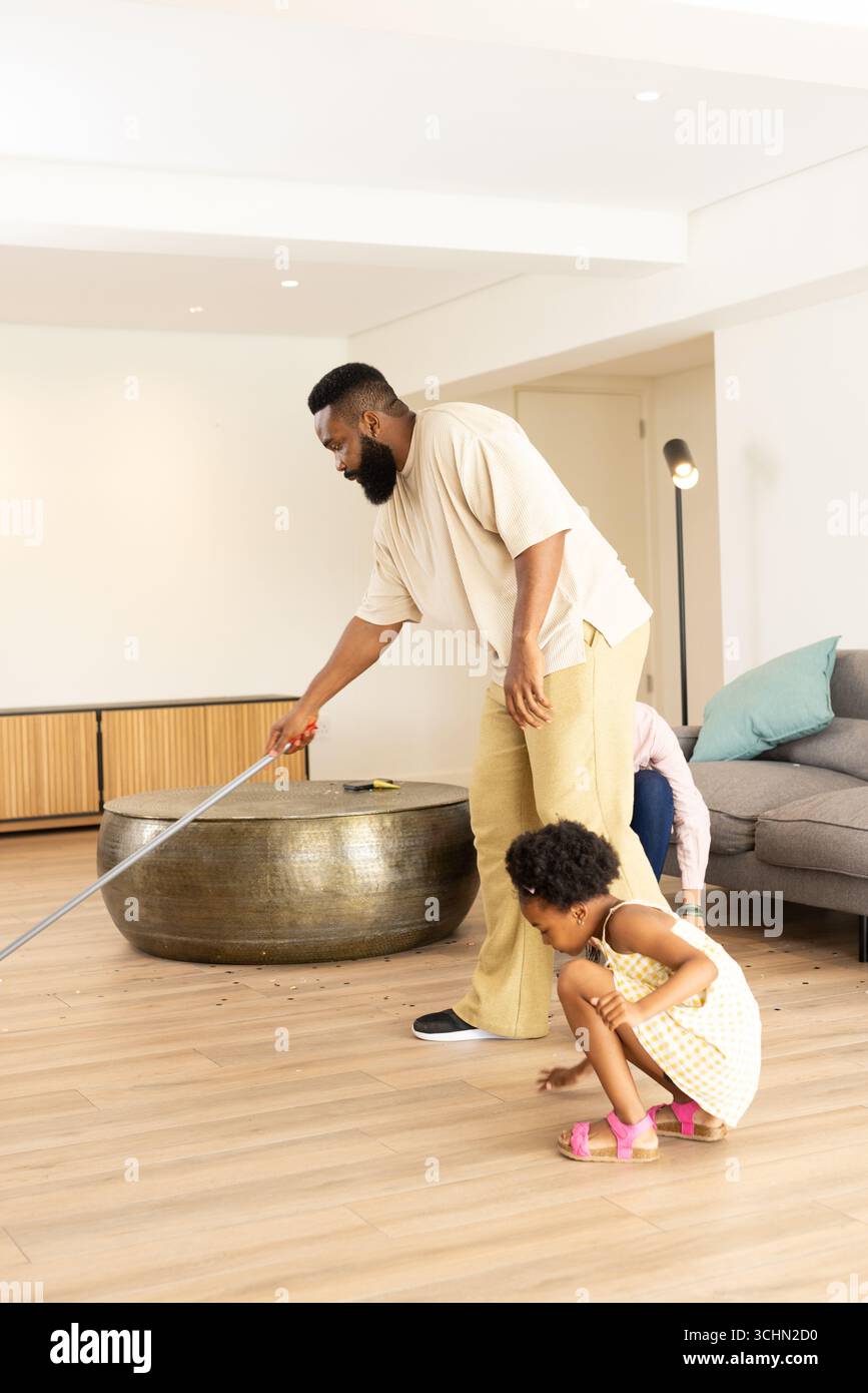 Father sweeping floor daughter hi-res stock photography and images - Alamy