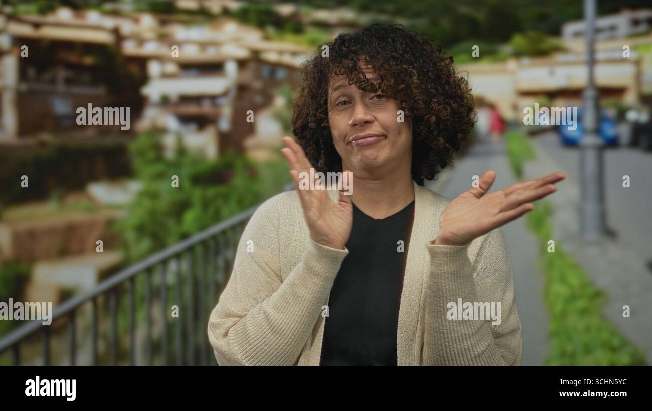 Middle aged woman shrugging with open palms and raised shoulders on ...
