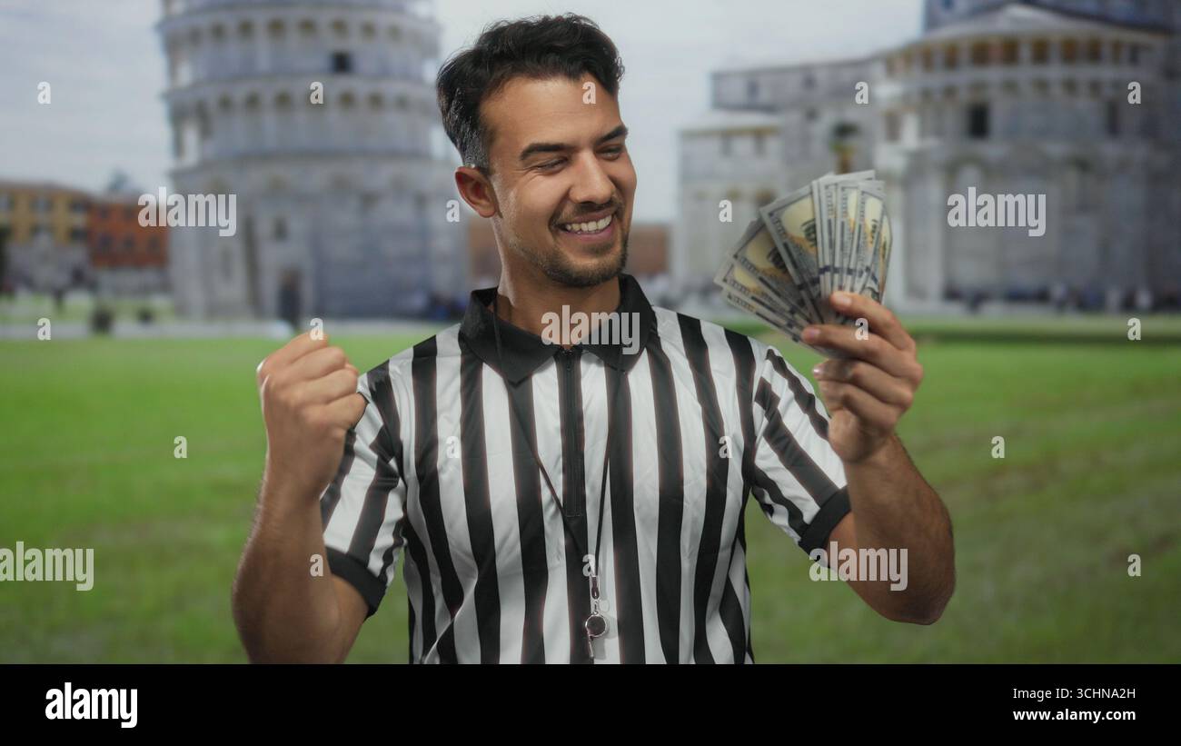 Young hispanic man in referee uniform holding us dollars with pisa ...