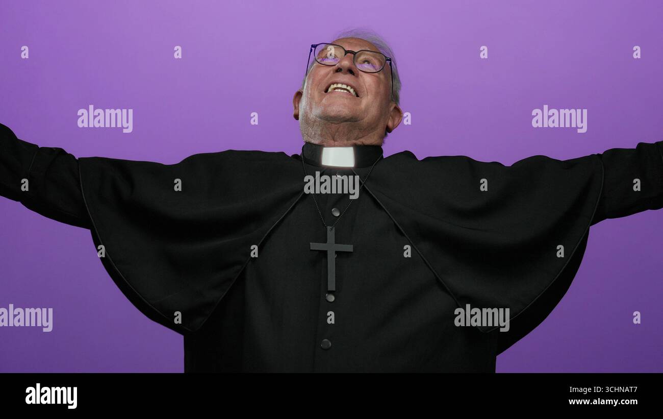Senior priest joyfully raising arms hi-res stock photography and images ...
