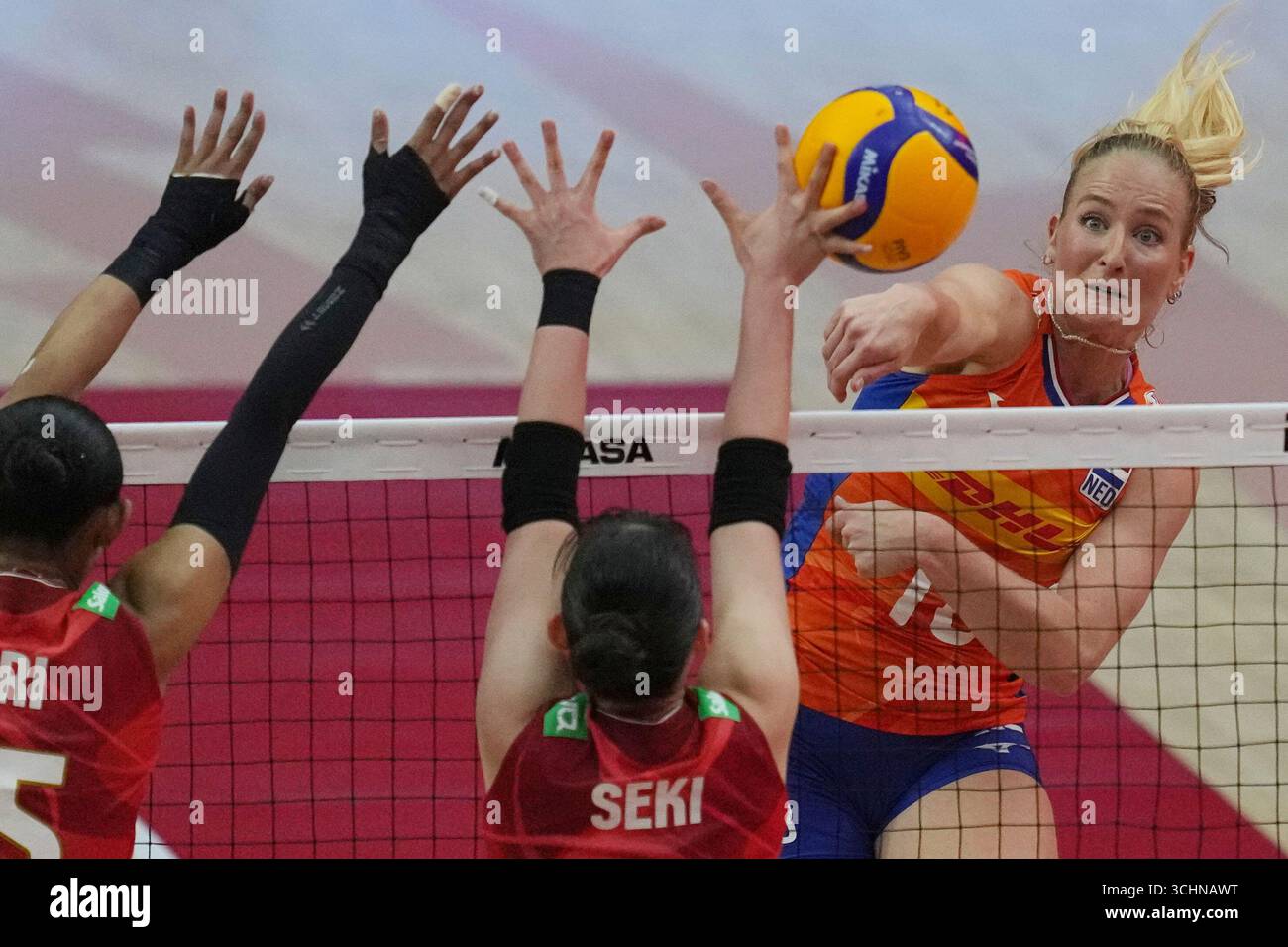 Netherlands' Marrit Jasper, right, spikes the ball against, Japan's ...