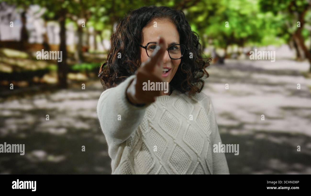 Woman curly hair playfully mimics hi-res stock photography and images ...