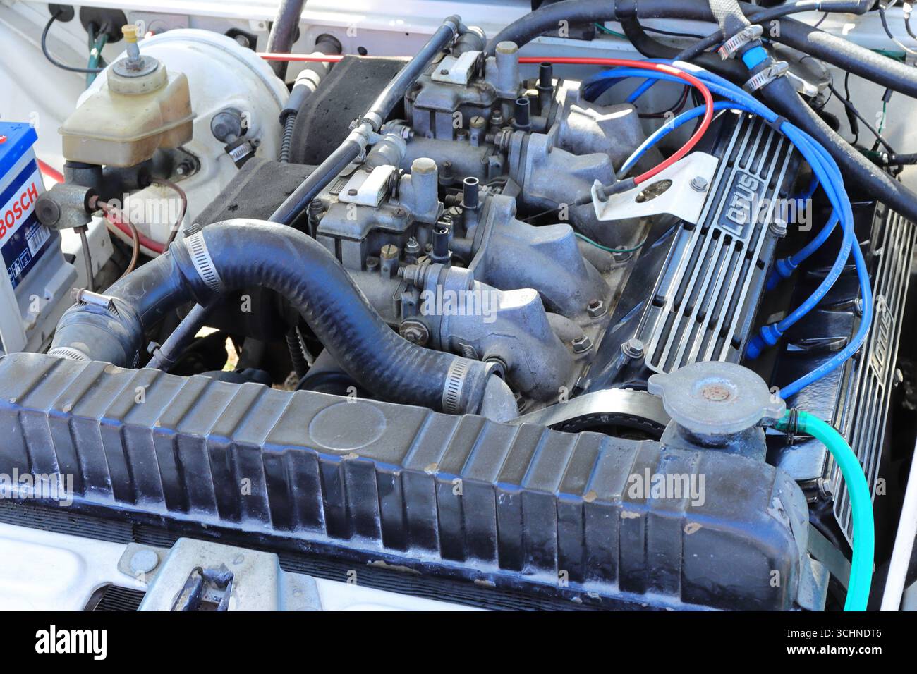 This image is a detailed view of a car engine bay, featuring a Lotus ...