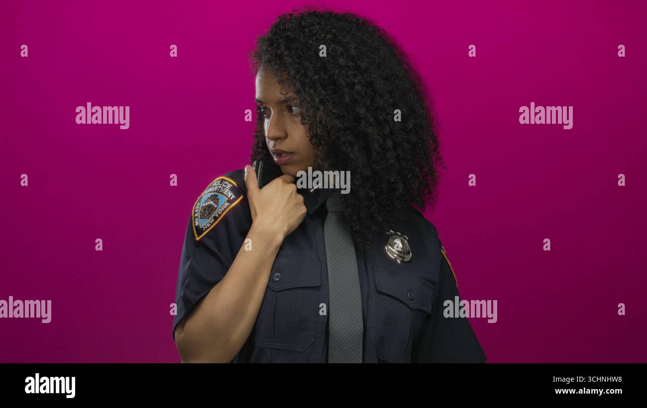 Young hispanic woman police officer in uniform holds radio handset to ...