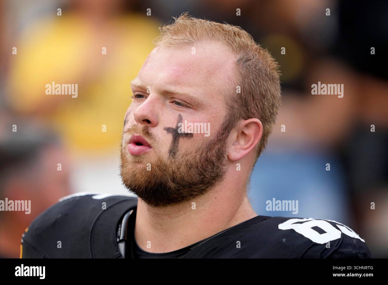 Iowa offensive lineman Logan Jones stands on the field before an NCAA ...