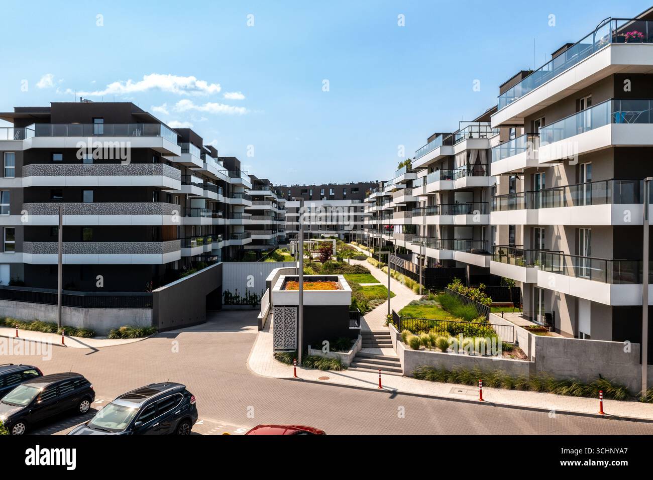 Street-level view of modern apartment buildings with landscaping and ...