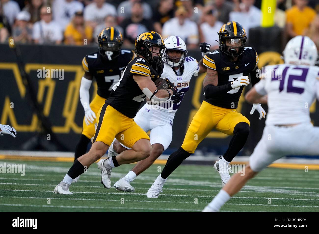 Iowa wide receiver Kaden Wetjen, left, returns a punt during the first ...
