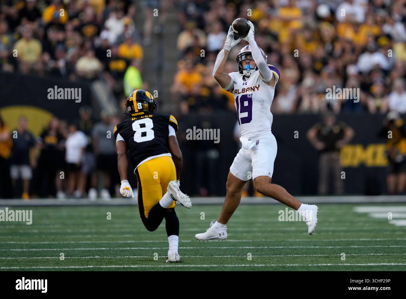 Albany wide receiver Caden Burti (19) catches a pass over Iowa ...