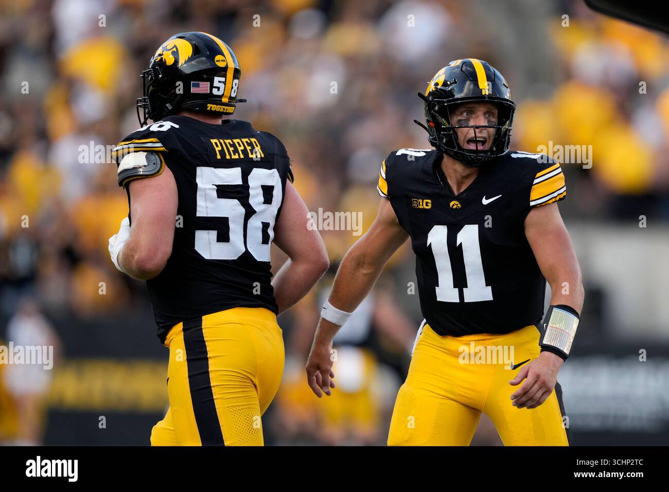 Iowa quarterback Mark Gronowski (11) reacts with teammate offensive ...