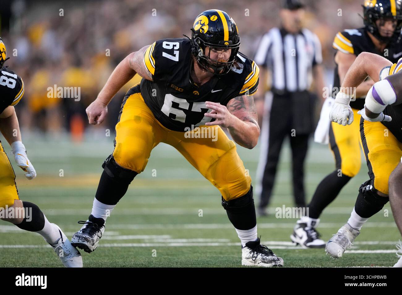 Iowa offensive lineman Gennings Dunker (67) looks to make a block ...