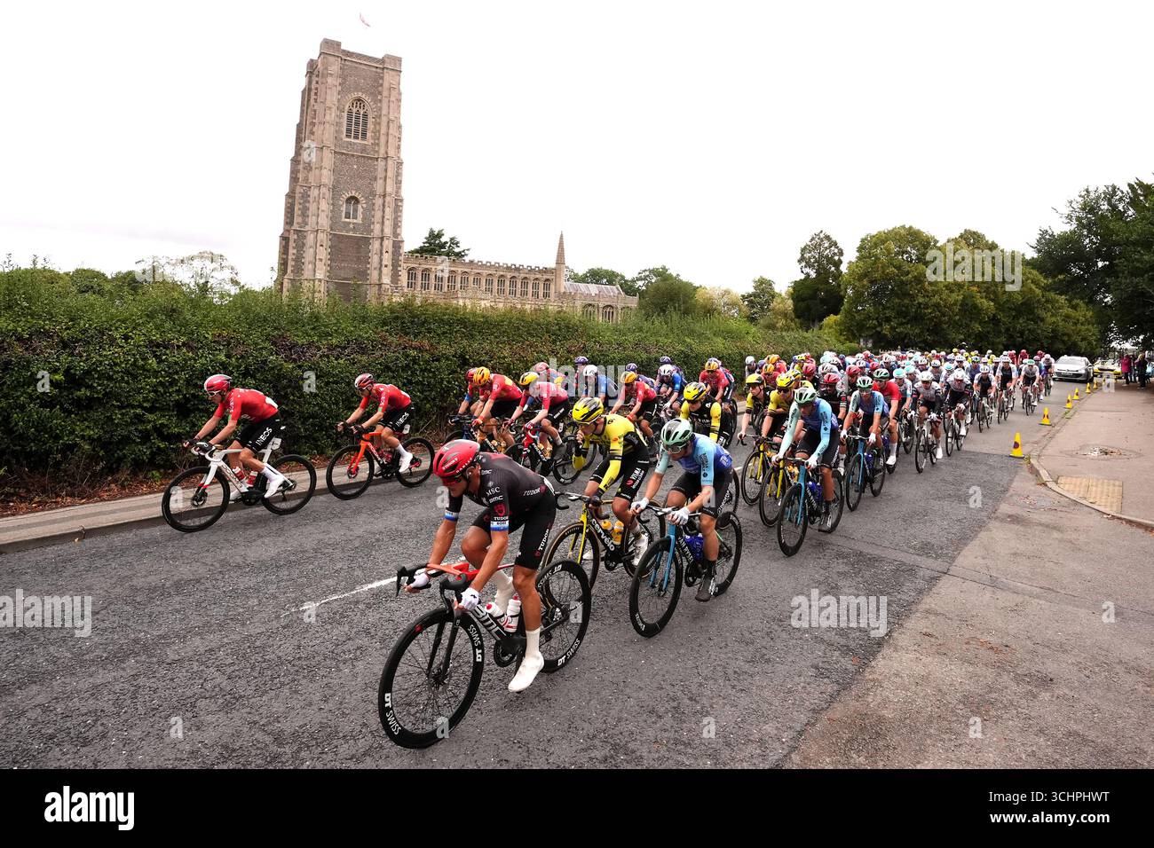 Riders past the St Peter & St Paul's Church in Lavenham during the 2025 ...