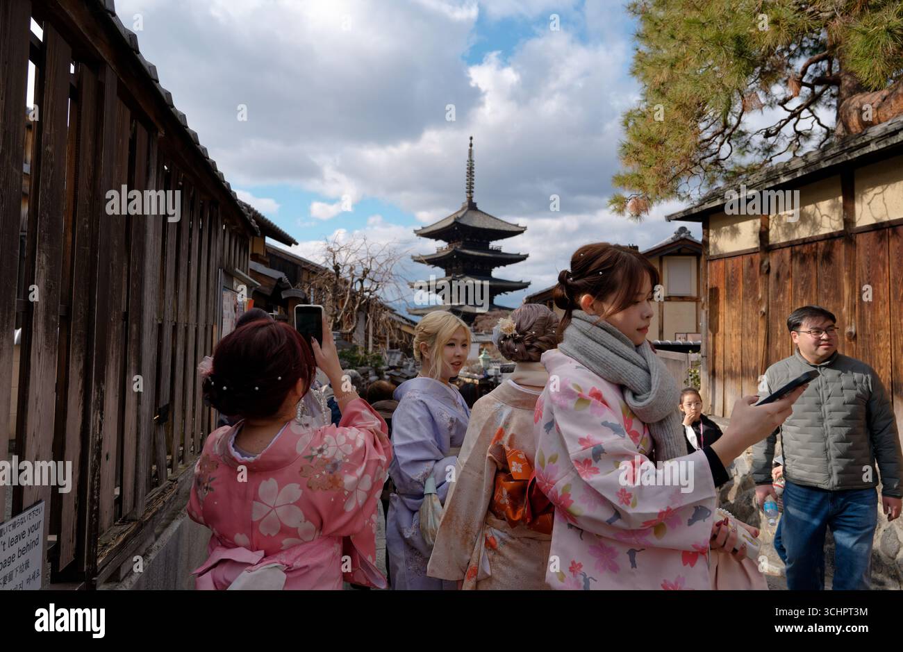 Young women in colorful kimonos gather on a street in Kyoto’s ...