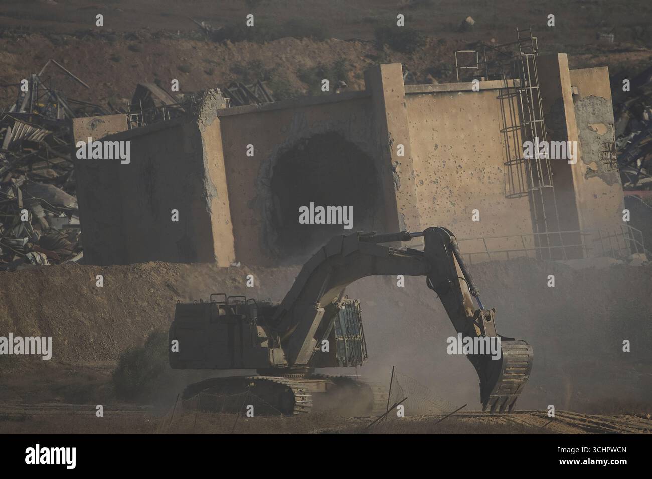 An Israeli military bulldozer operates inside the Gaza Strip as seen ...