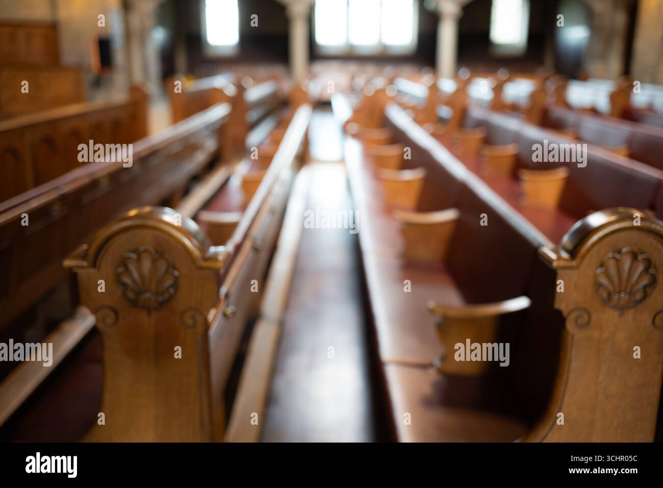 Blurred image of empty pews inside protestant church in Europe. Wide ...