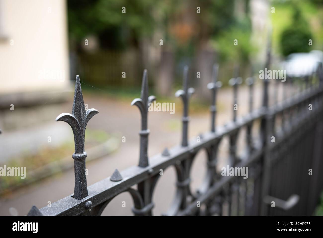 Wrought iron fence with sharp, pointy ends. Side view, shallow depth of ...