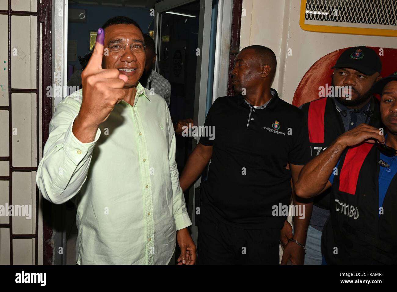 Prime Minister Andrew Holness, leader of the Jamaica Labor Party, shows ...