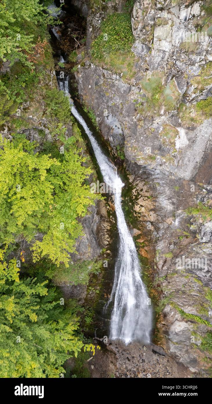 Aerial view of Sutovsky waterfall cascading through lush forest in Mala ...