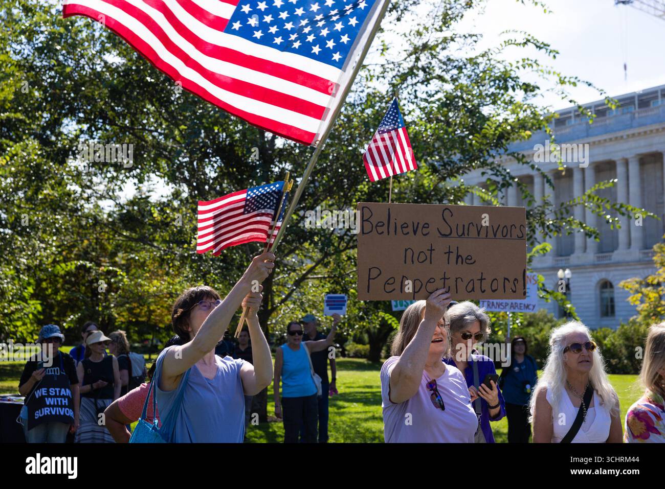 Supporters of women who survived Jeffrey Epstein and Ghislaine Maxwell are seen during a rally ...