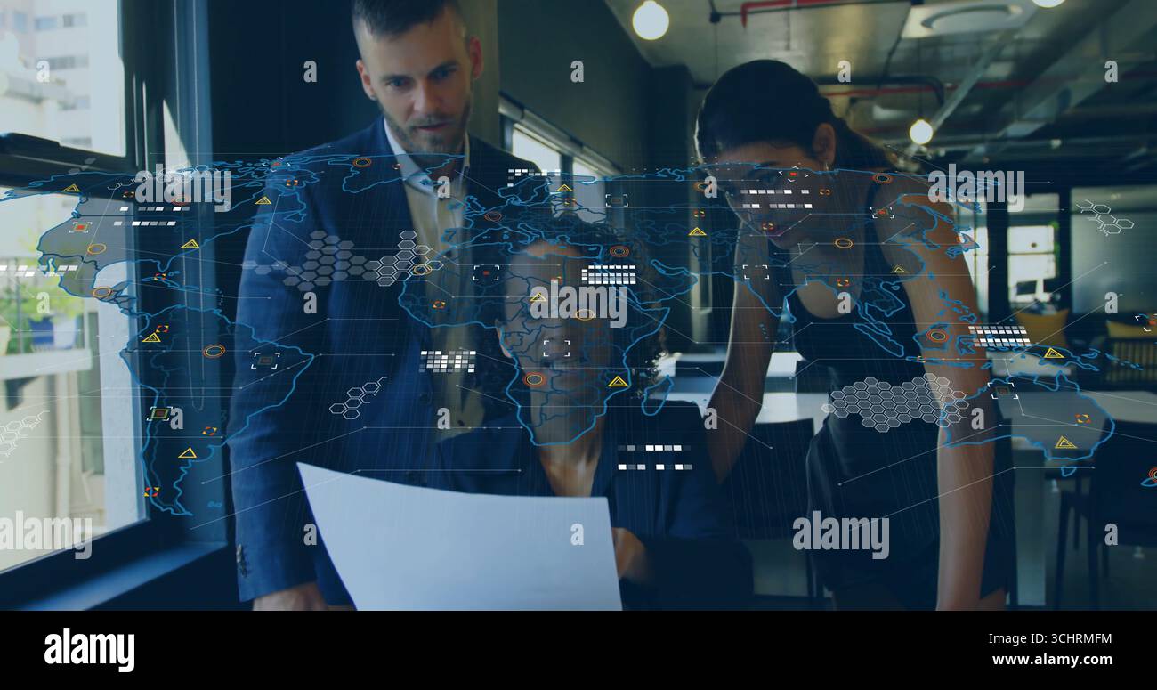 Colleagues reviewing printed report wearing business attire in open ...