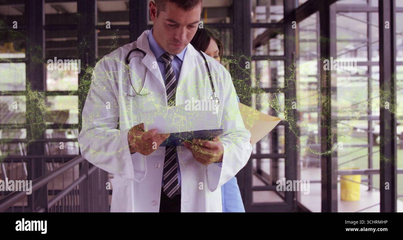 Holding paper documents male doctor reading chart in glass hospital ...